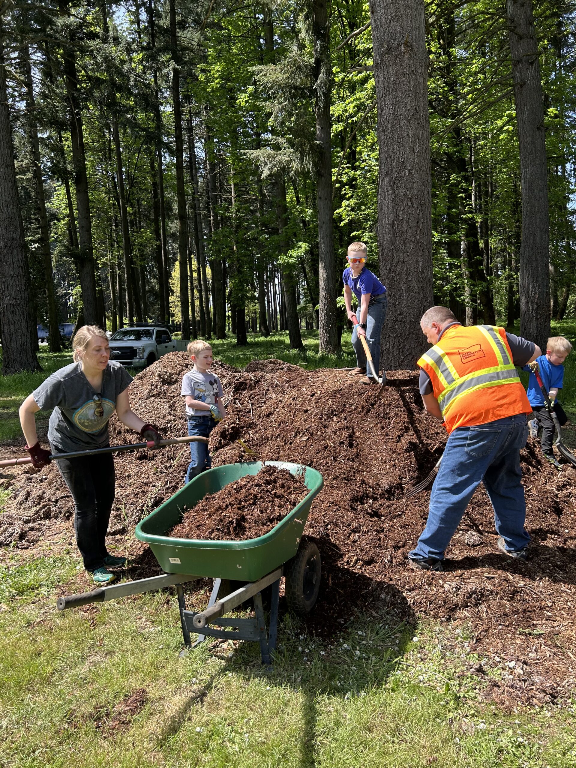 Beth, Mike and kids chip pile - Oregon Travel Information Council